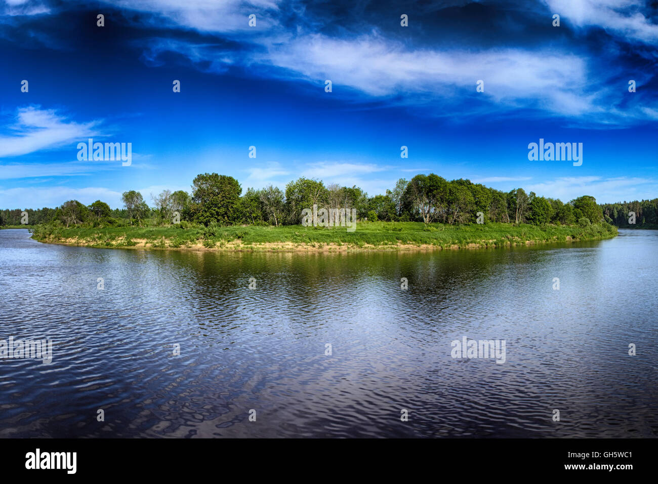 small green island in blue lake Stock Photo - Alamy