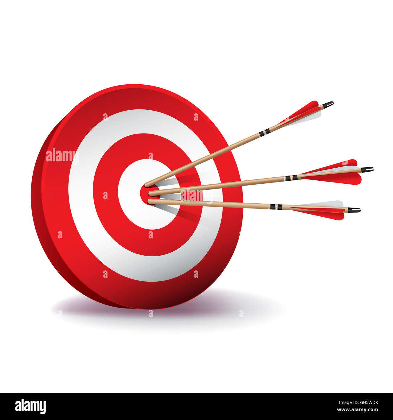 A red archery target with red and white fletched wooden arrows in the ...