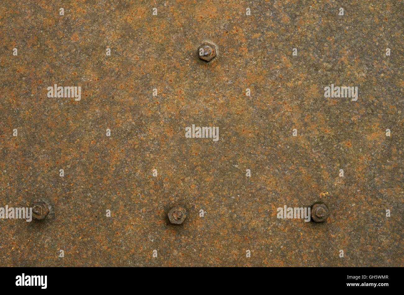 A texture of rust covering metal sheet and four bolts Stock Photo - Alamy
