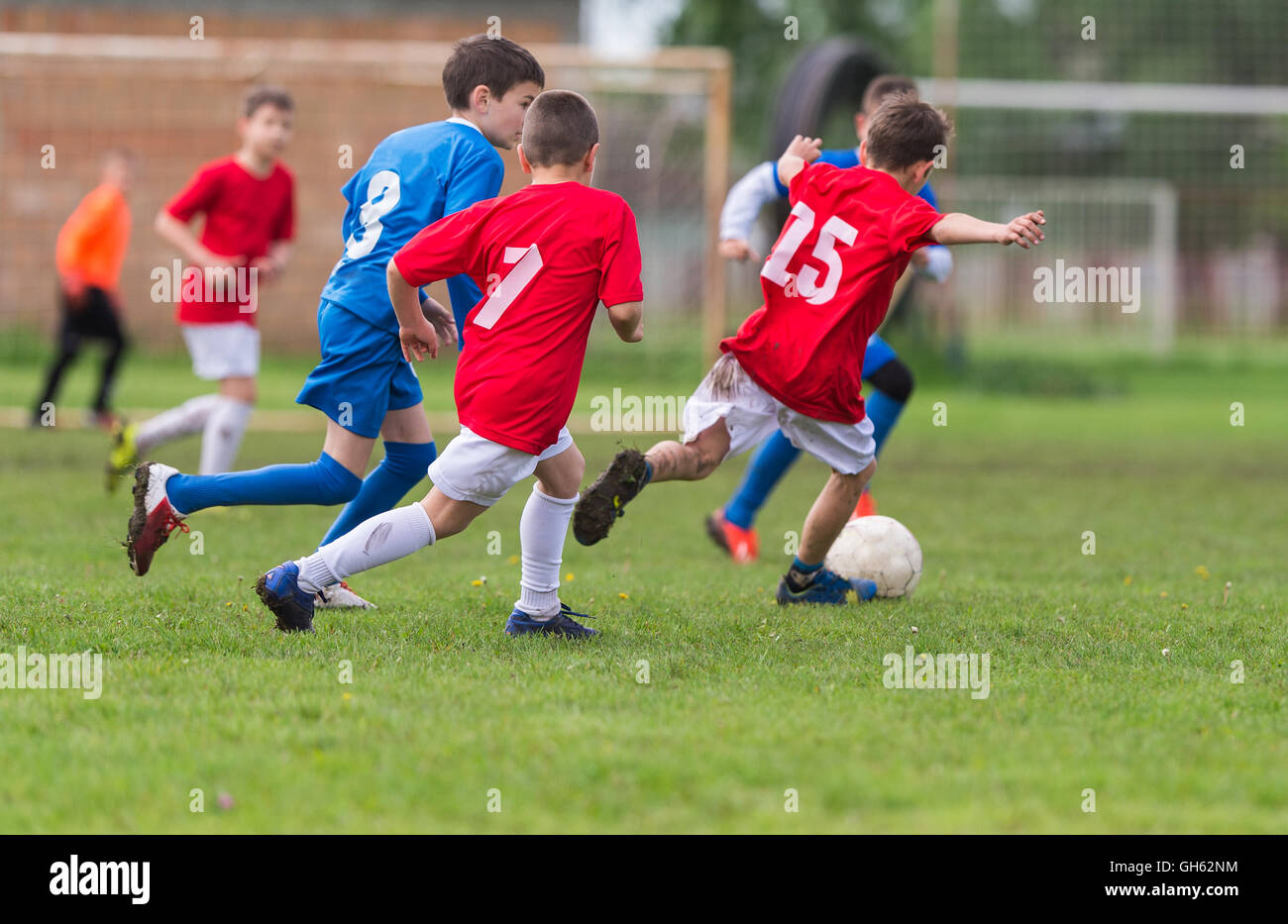 boys kicking football on the sports field Stock Photo - Alamy