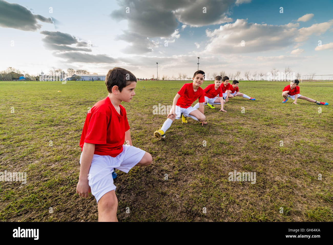Kids soccer team exercise on soccer field Stock Photo - Alamy