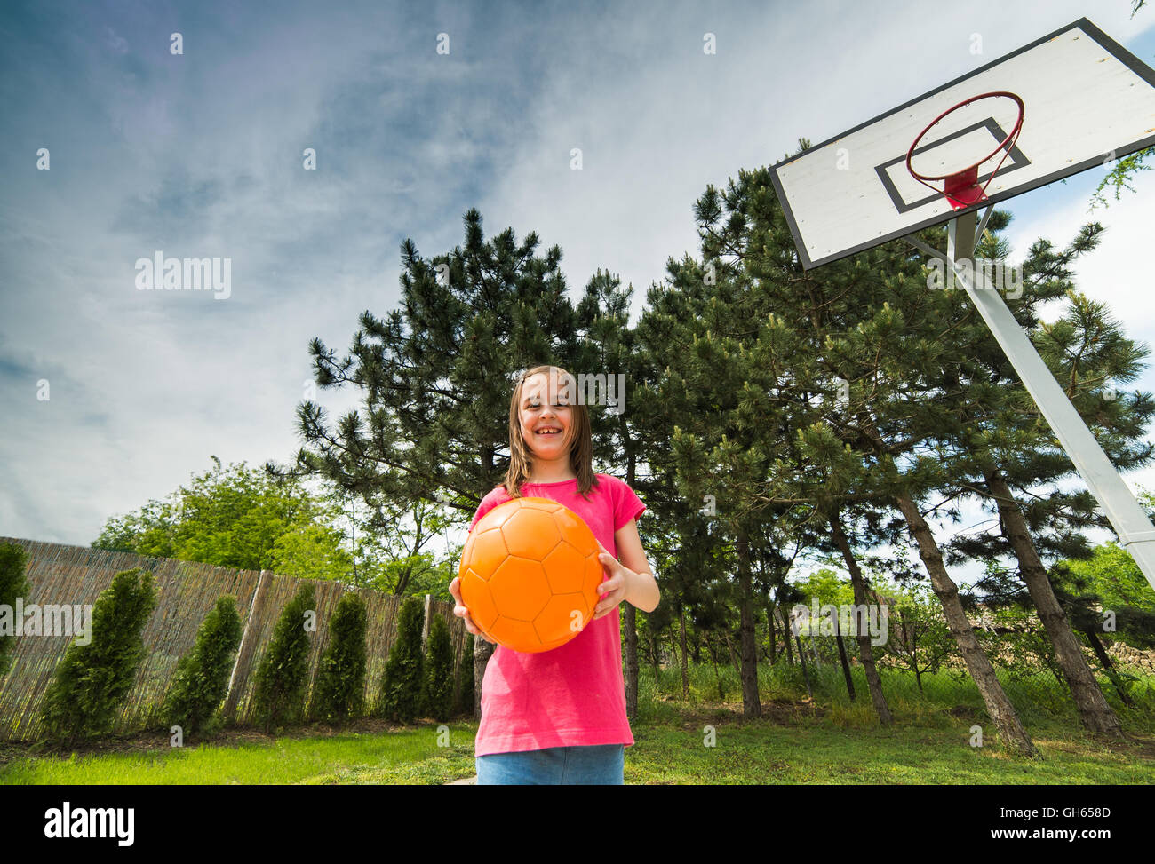 Smiling Girl basketball with ball Stock Photo - Alamy
