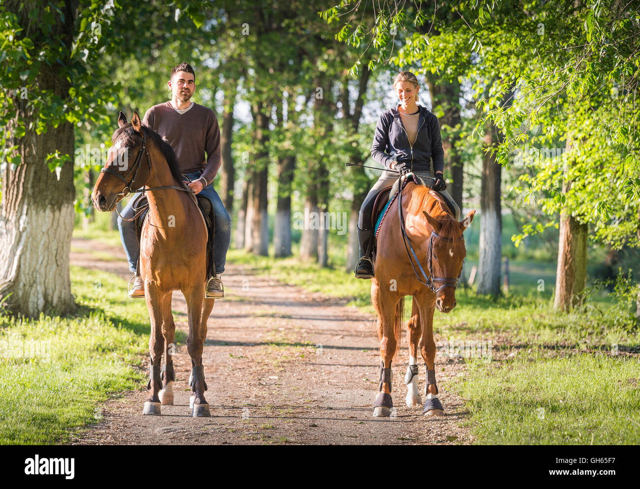 Young couple in love riding a horse Stock Photo - Alamy