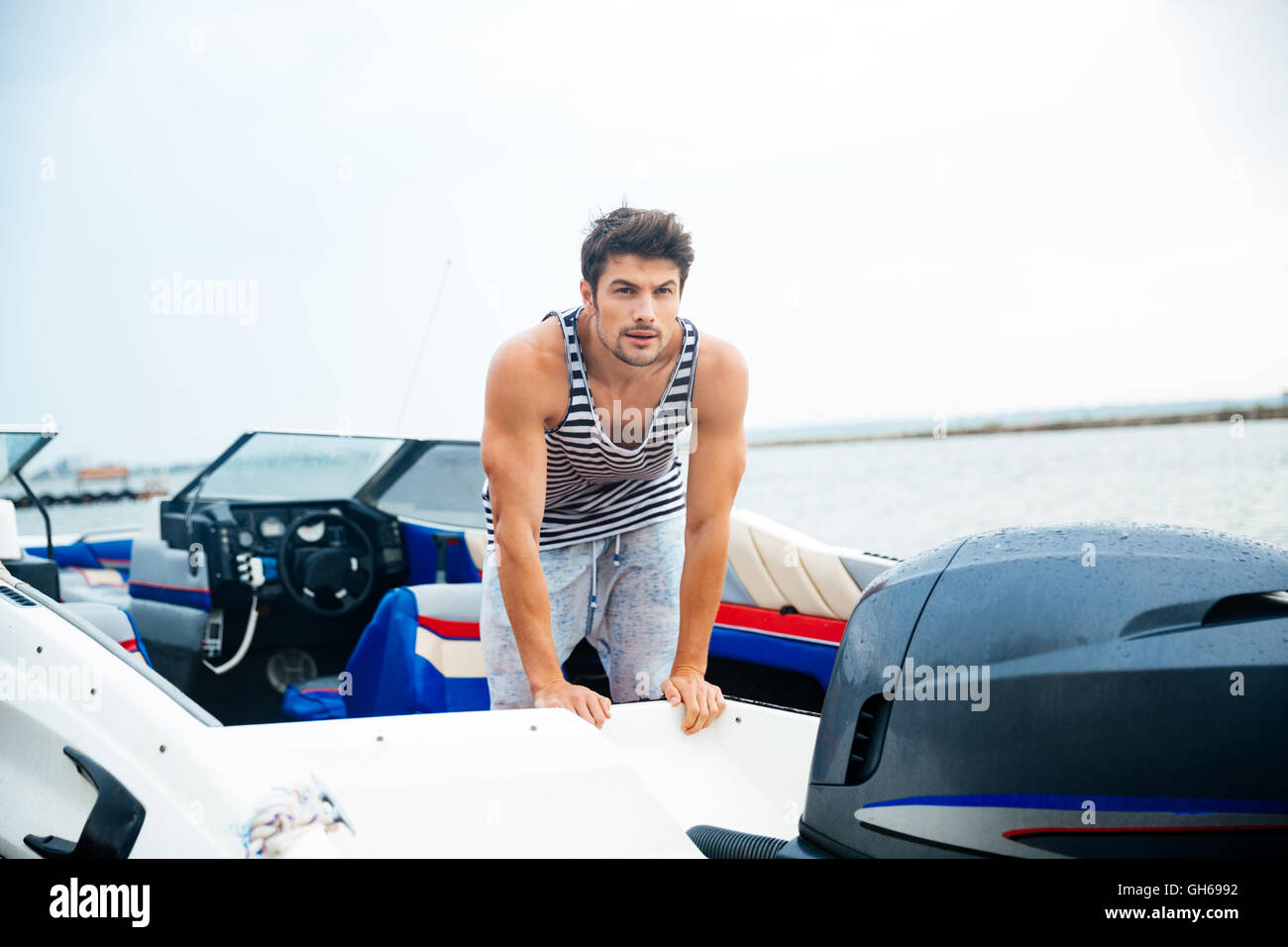 Young sailor man in his motor boat Stock Photo - Alamy