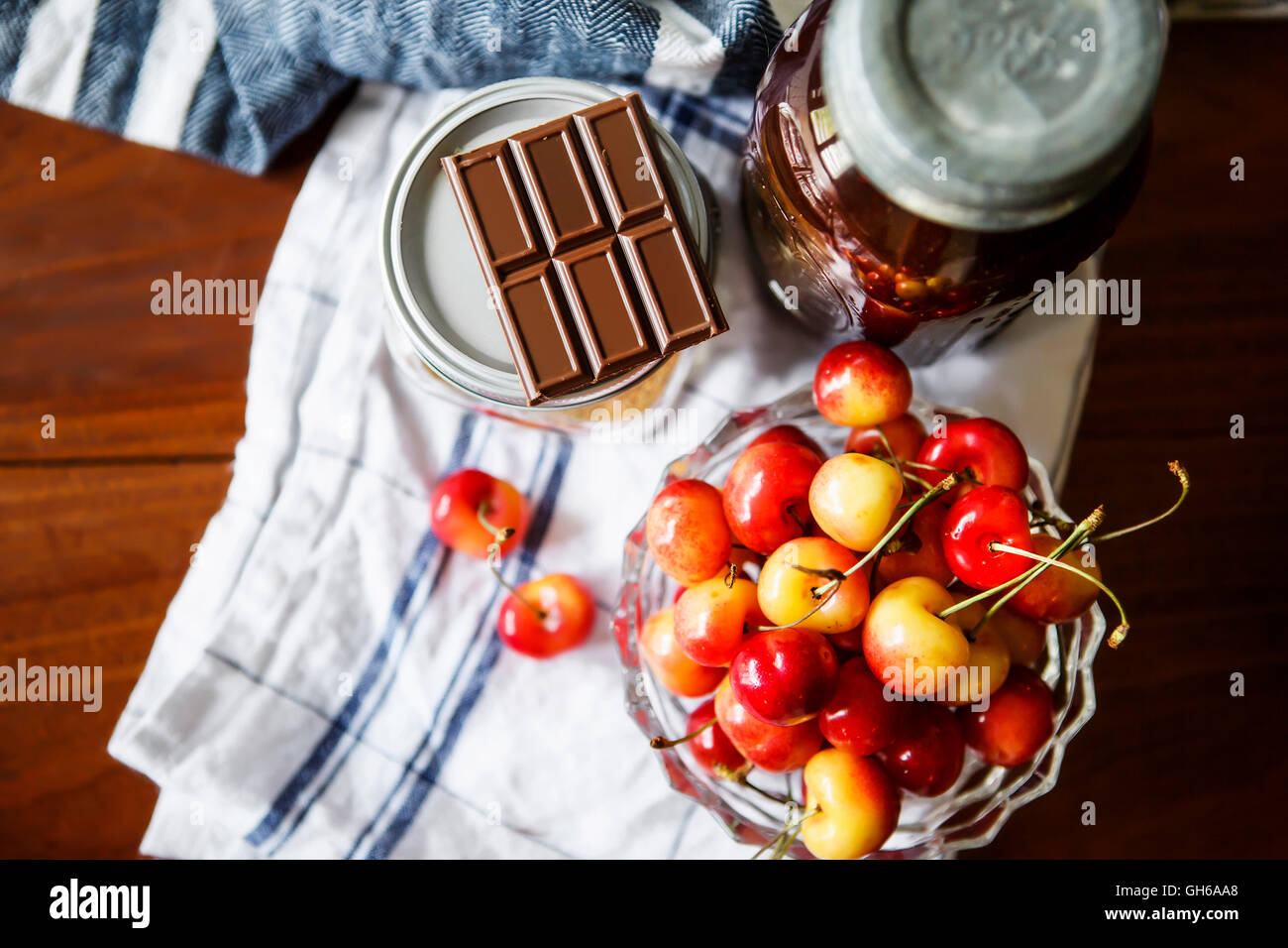 Rainier cherries, chocolate, and jelly in a rustic kitchen setting ...