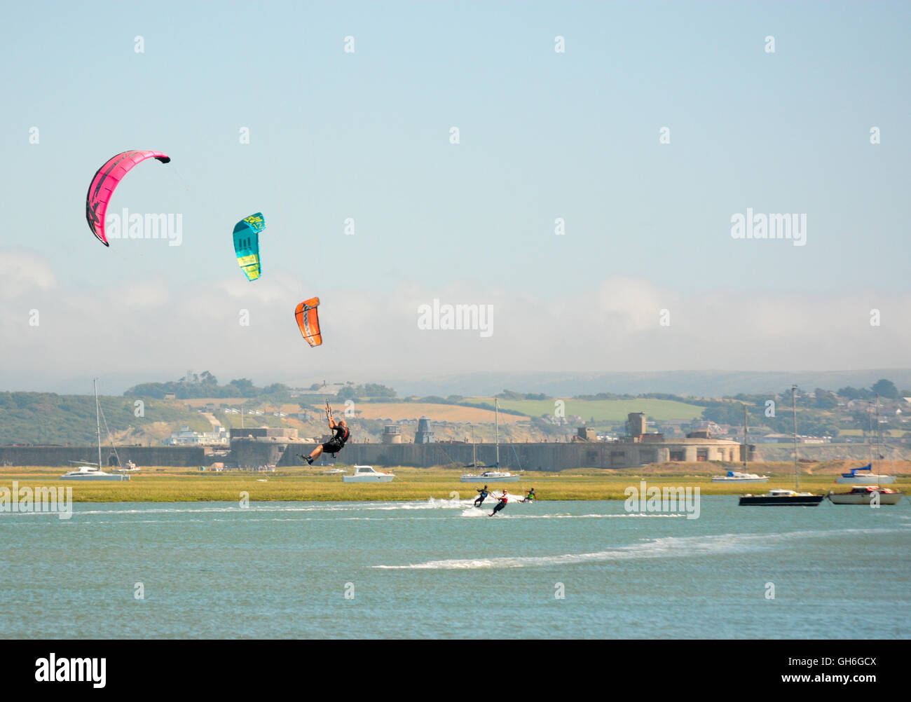 Kiteboarders make the most of a windy day in the lagoon behind the ...