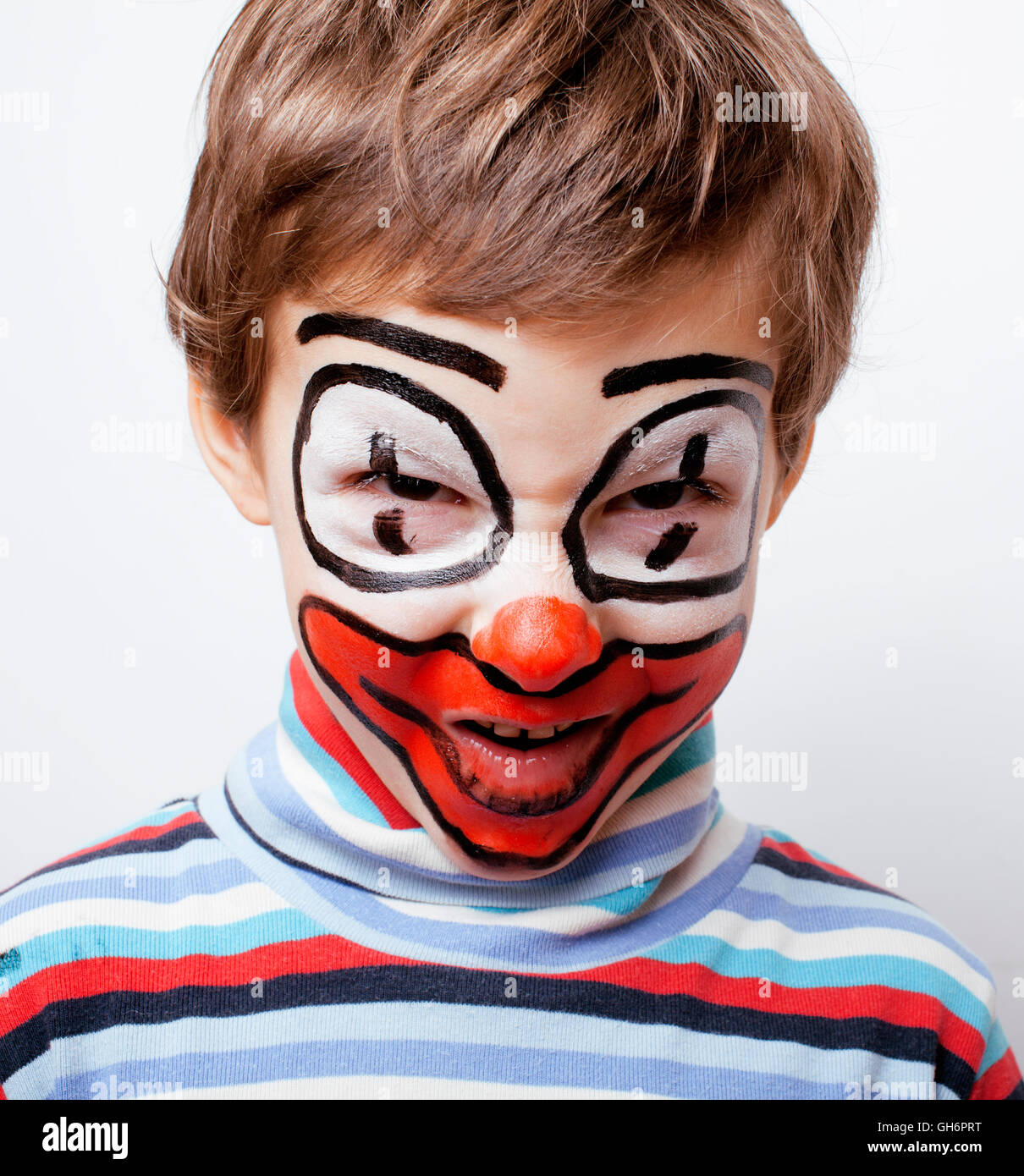 little cute boy with facepaint like clown, pantomimic expressions close ...