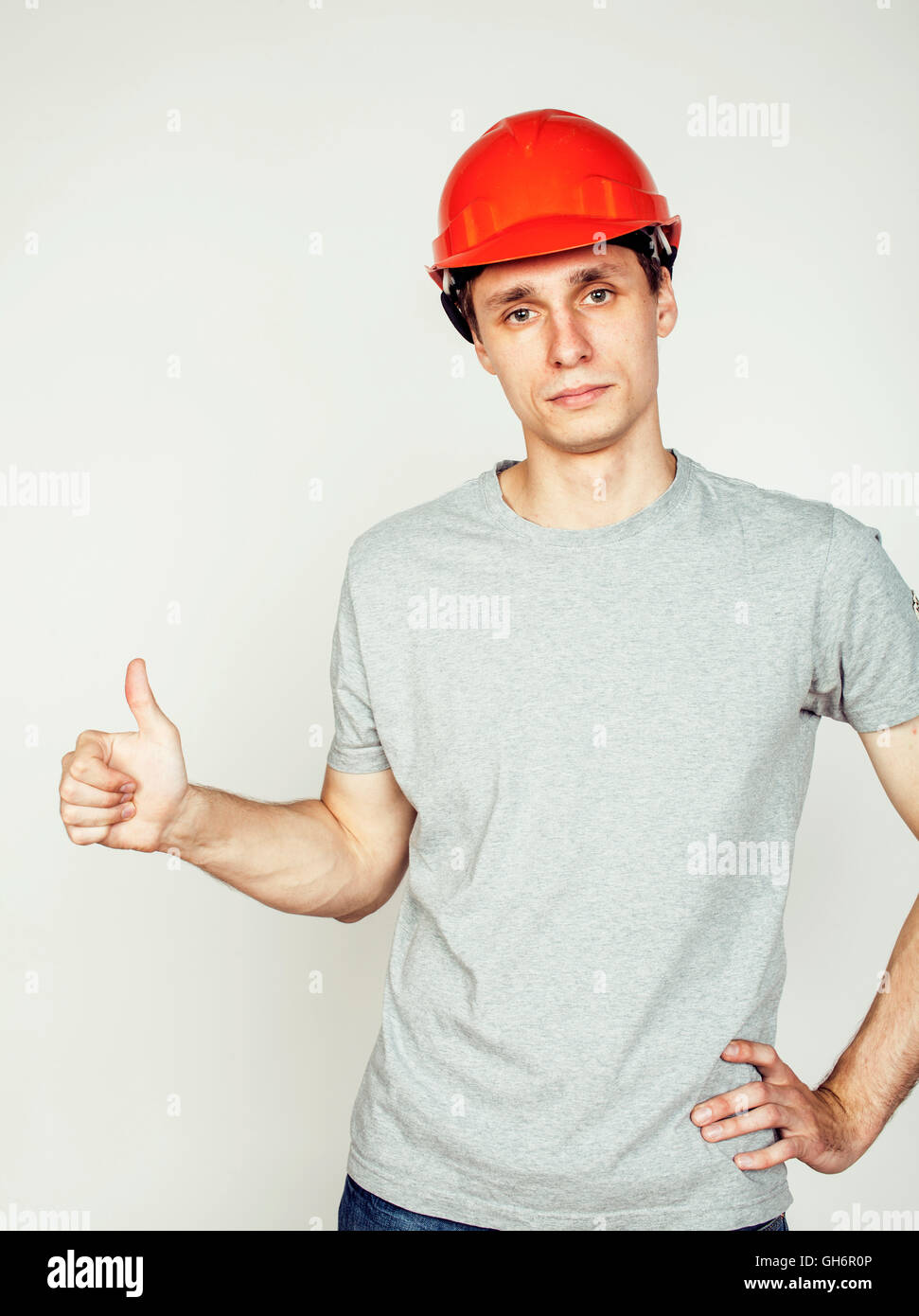 young real hard worker man isolated on white background on ladder ...