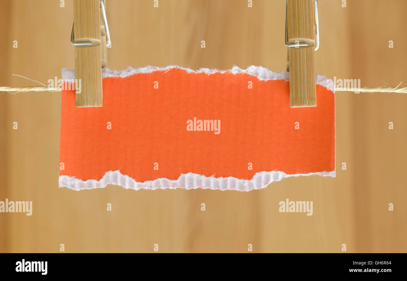 blank orange piece of paper and clothes peg Stock Photo - Alamy