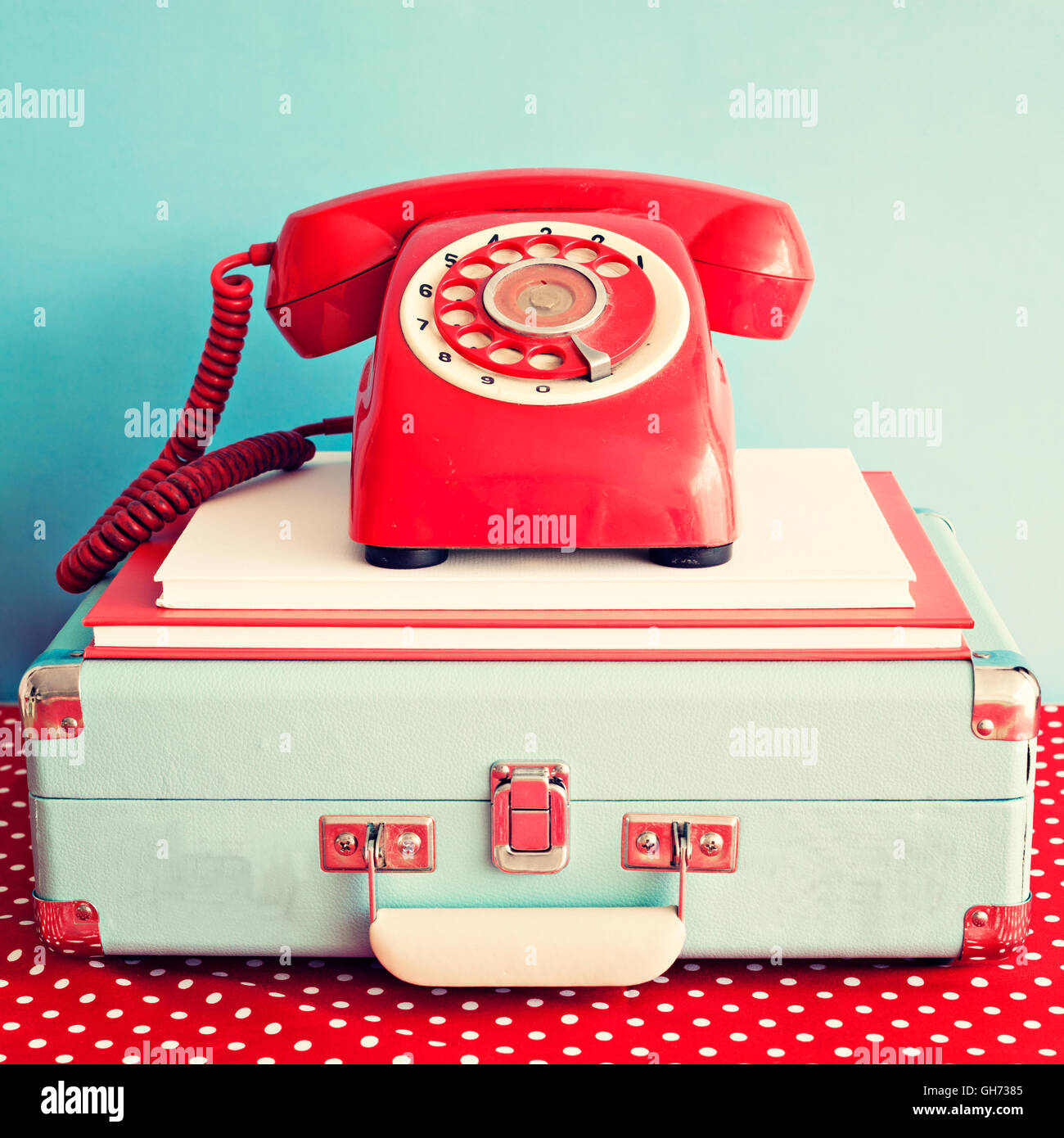 Vintage telephone over books and briefcase Stock Photo - Alamy