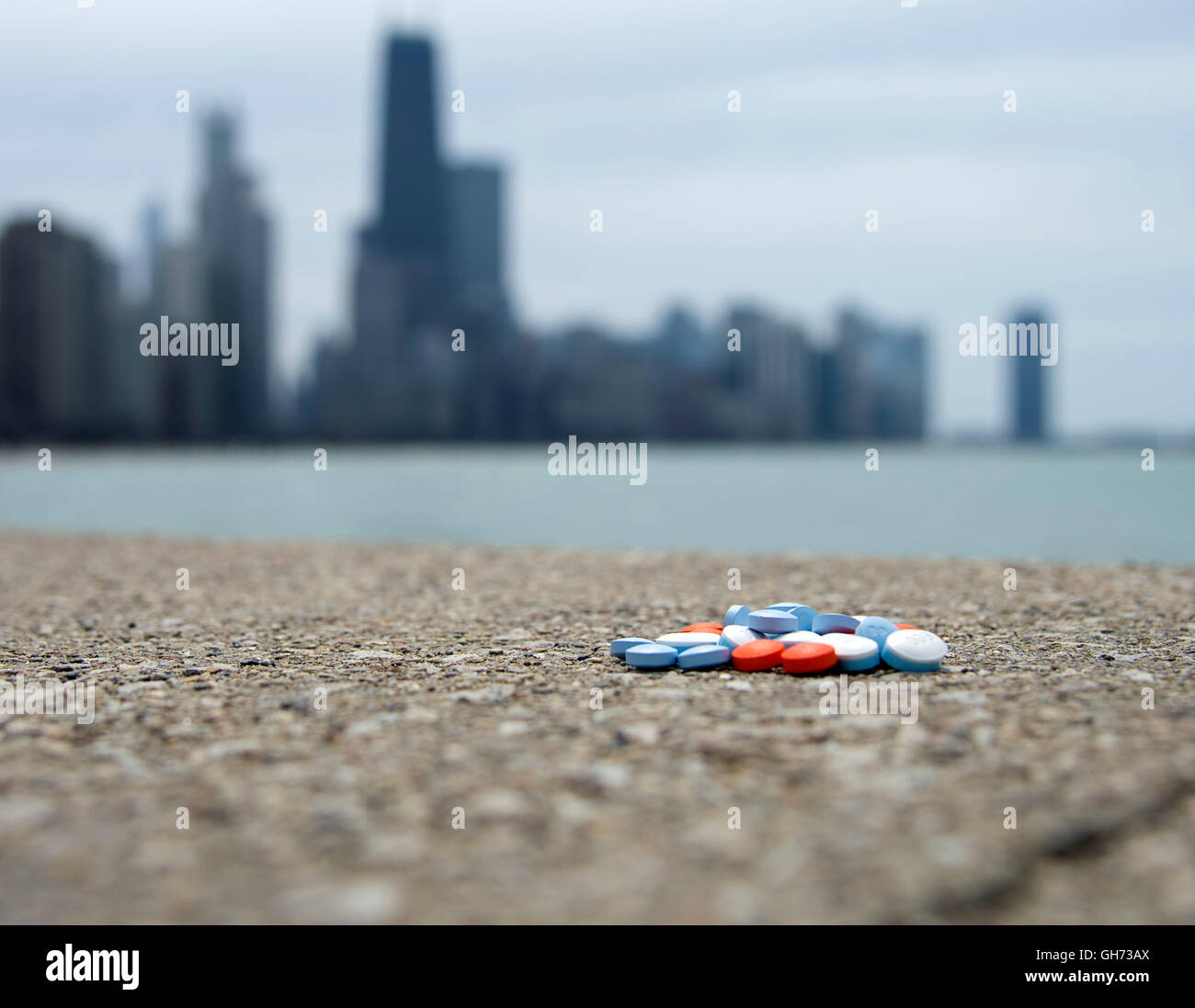 Pills on the ground with the blurred Chicago skyline in the background ...