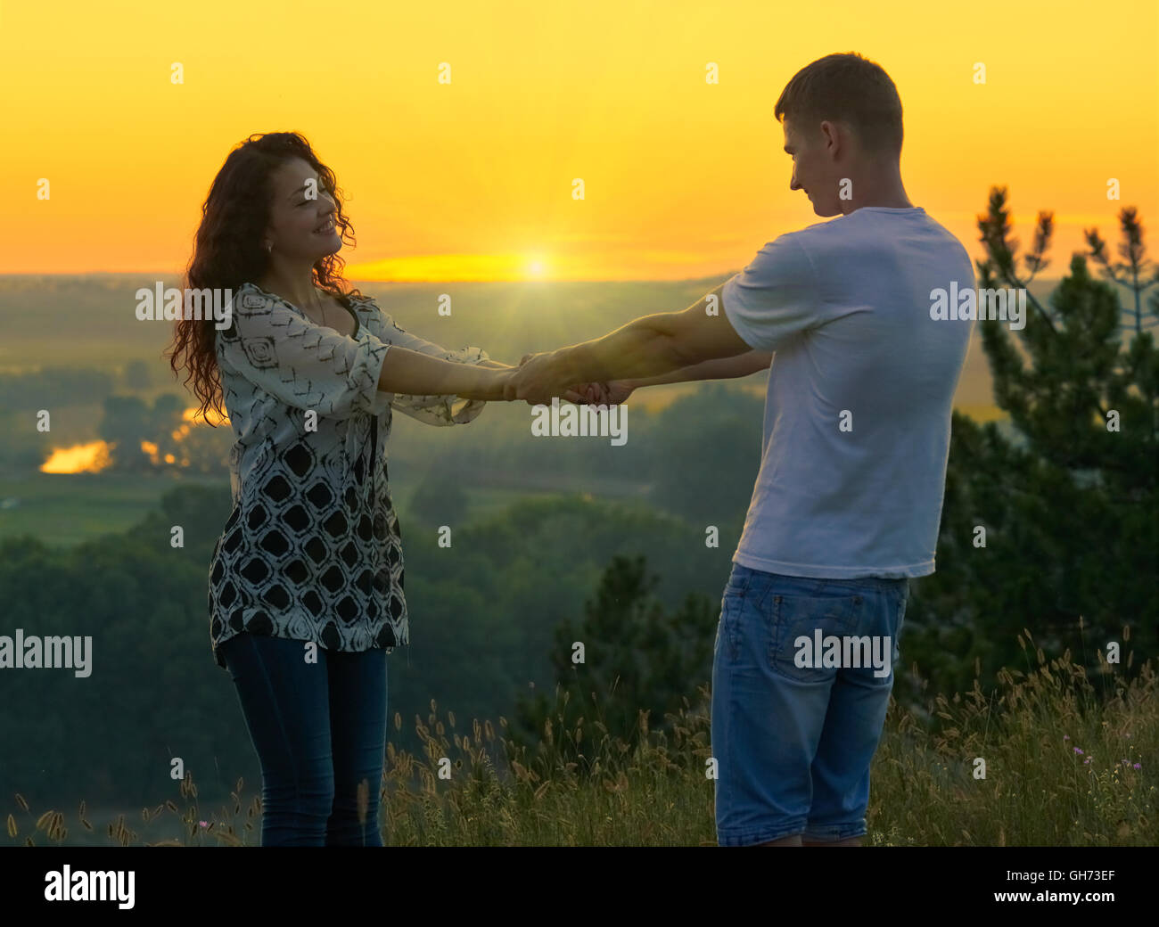 romantic couple holding hands at sunset on outdoor, beautiful landscape ...