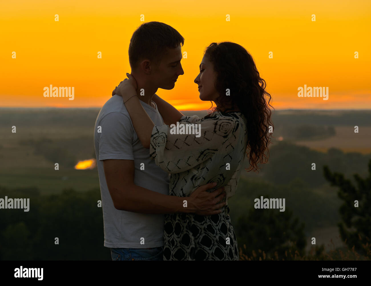 romantic couple at sunset on outdoor, beautiful landscape with bright ...