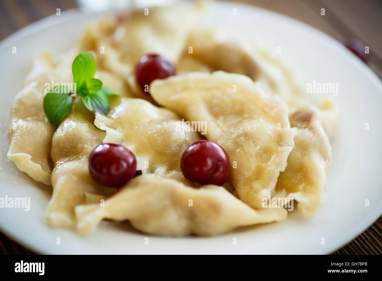 Cherry dumplings with mint Stock Photo - Alamy