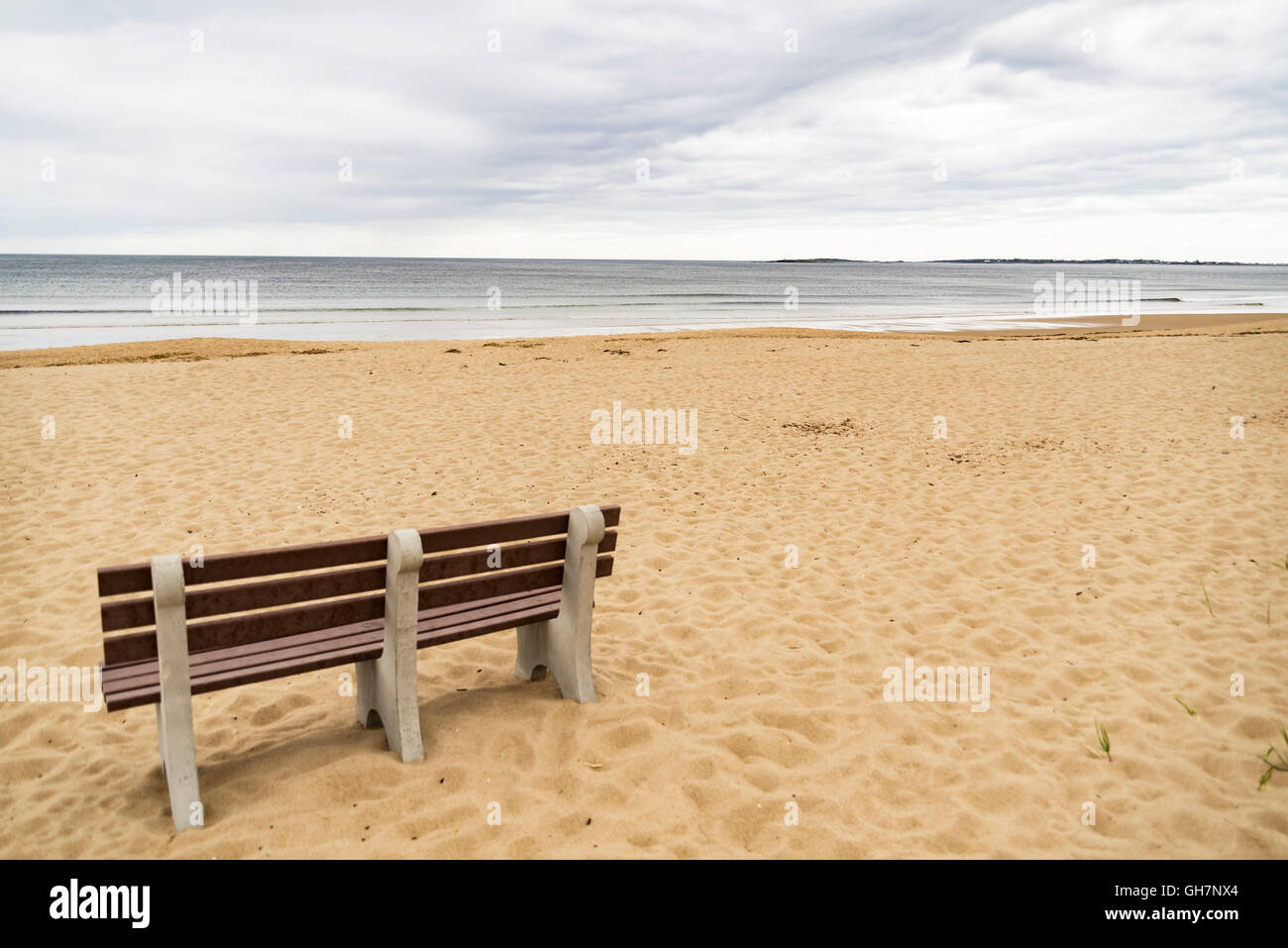 Bench on ocean beach Stock Photo - Alamy