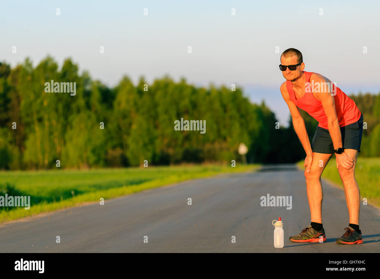 Man runner running on country road, training inspiration and motivation ...