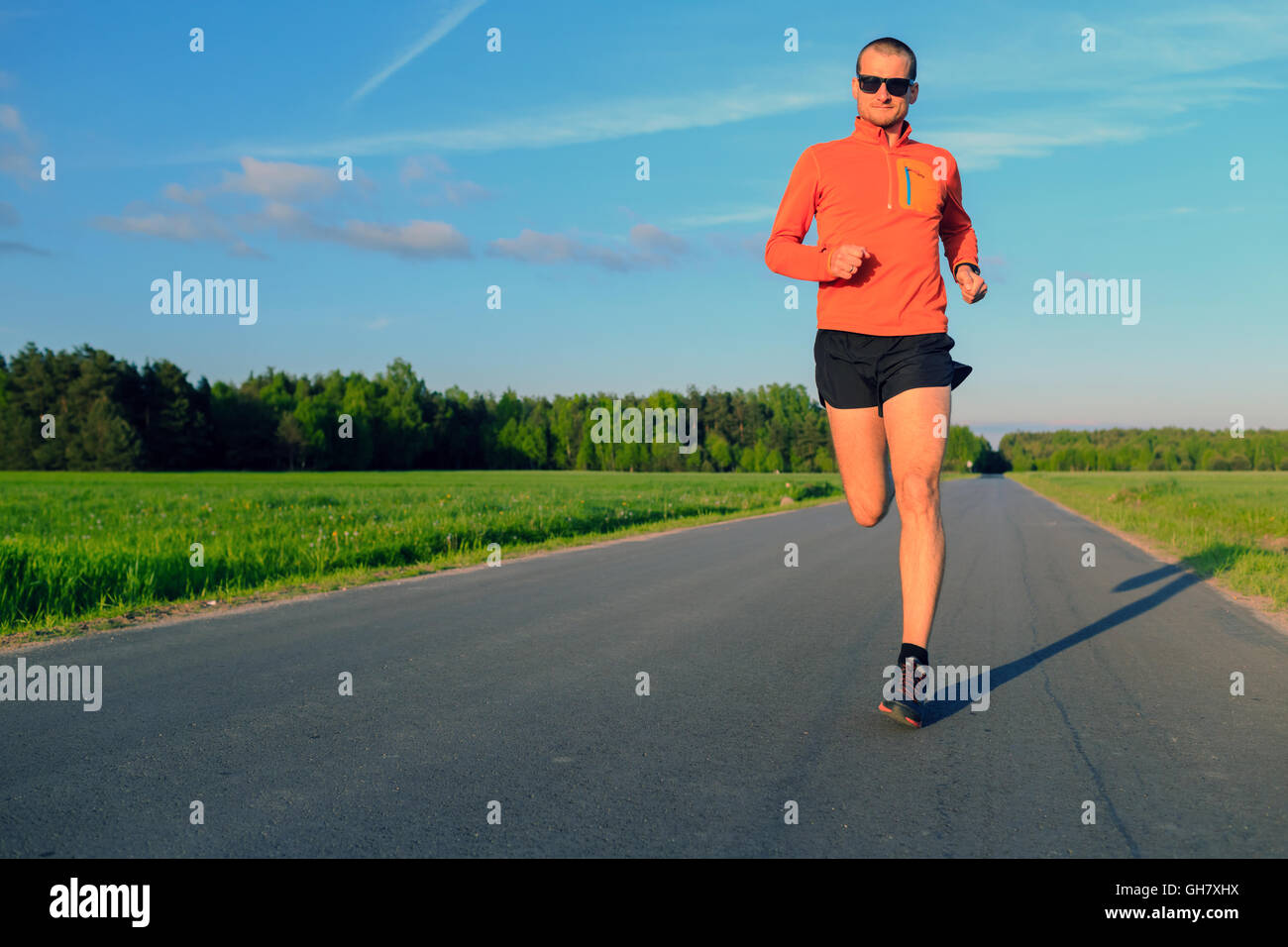 Man runner running on country road, training inspiration and motivation ...