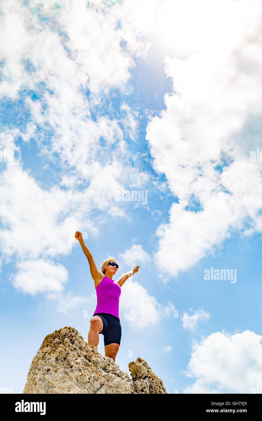 Happy smiling woman on successful climbing, running or hiking ...
