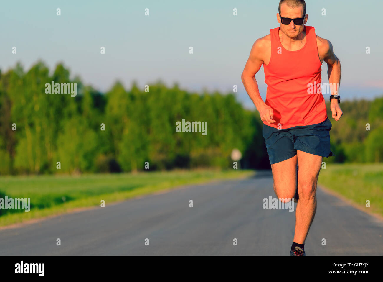 Man runner running on country road, training inspiration and motivation ...