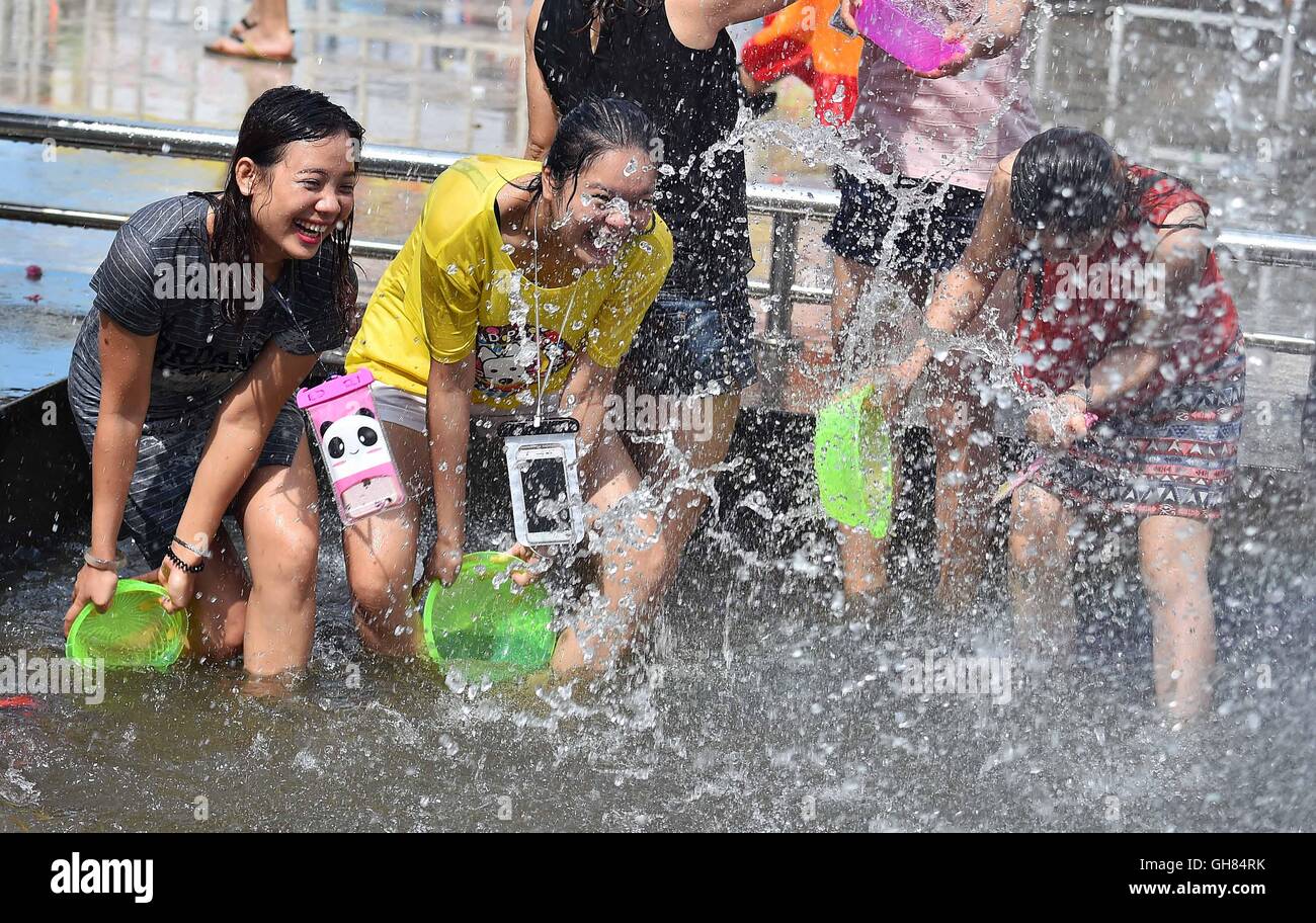 Baoting, China's Hainan Province. 9th Aug, 2016. People splash water at ...