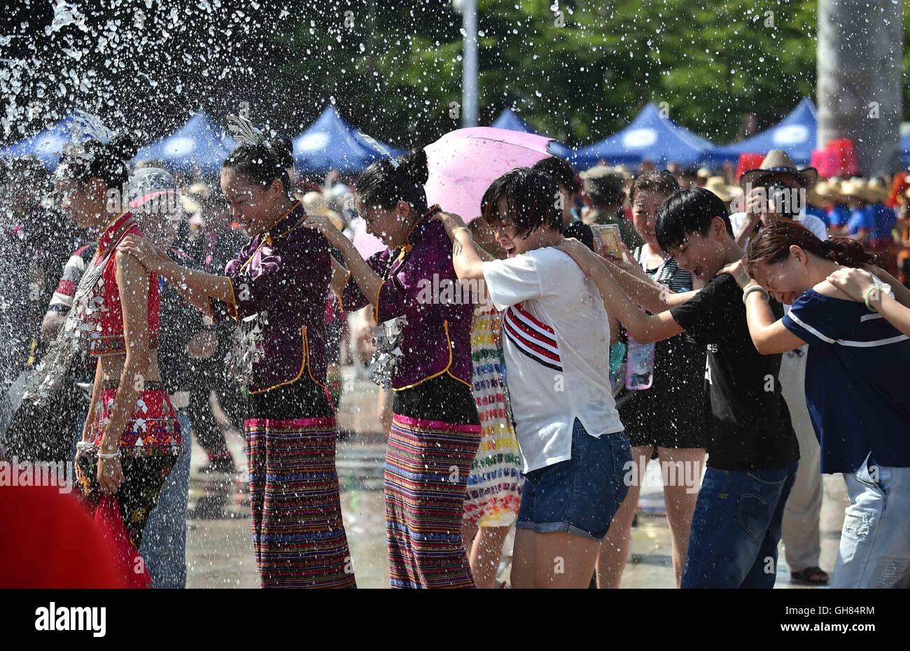Baoting, China's Hainan Province. 9th Aug, 2016. People splash water at ...