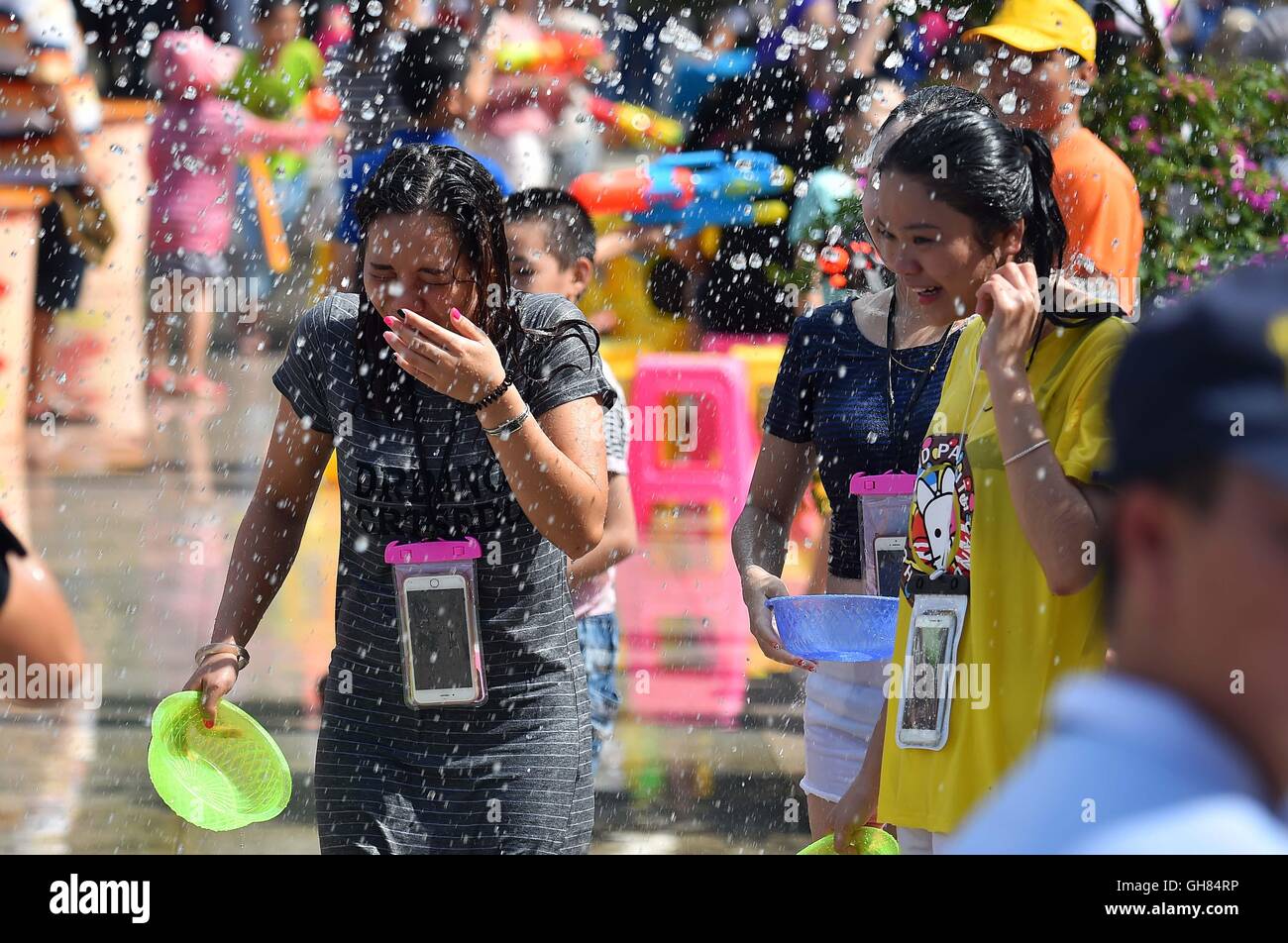 Baoting, China's Hainan Province. 9th Aug, 2016. People splash water at ...