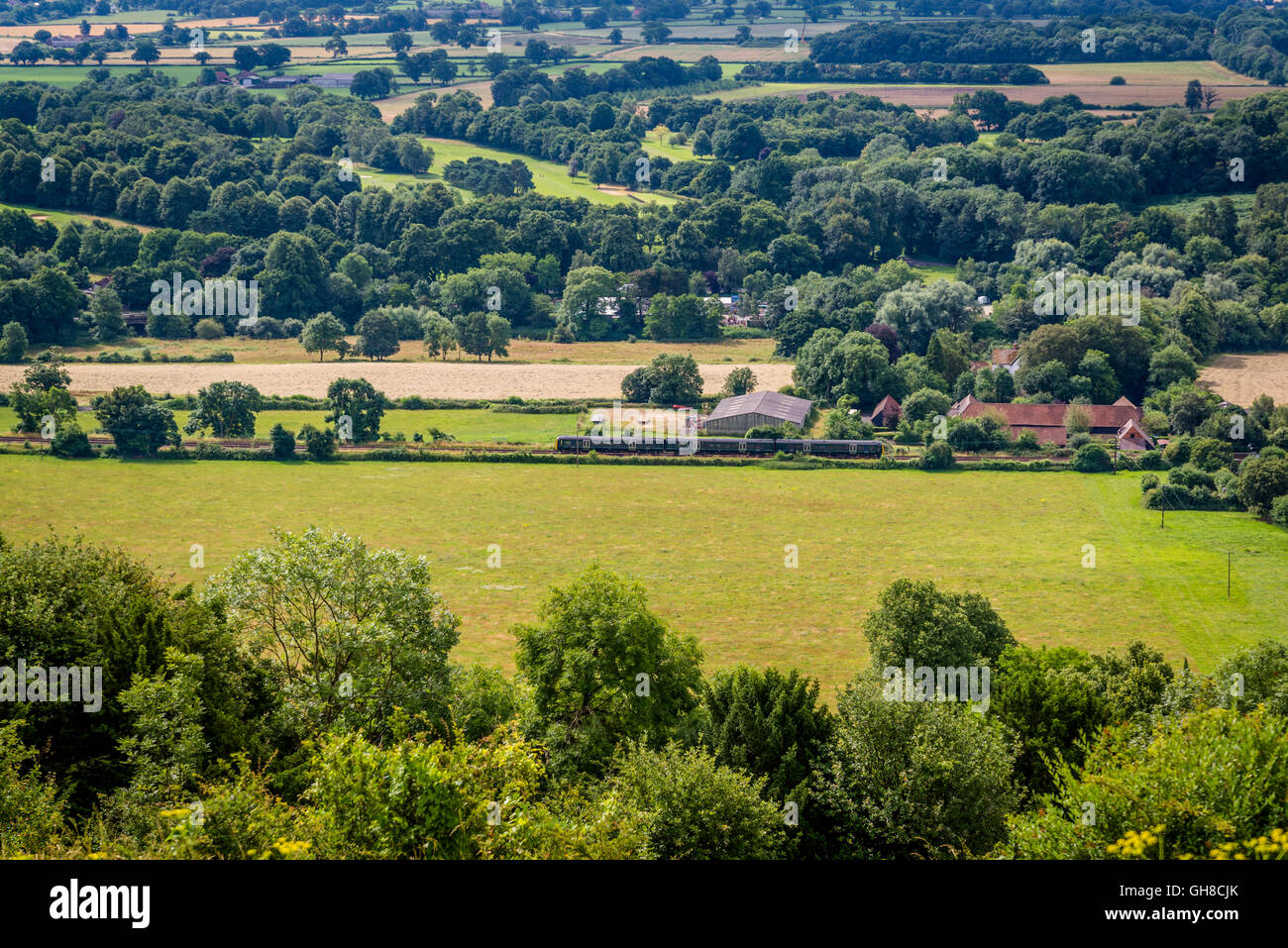 Train passing through The Mole valley in Surrey between the North Downs ...