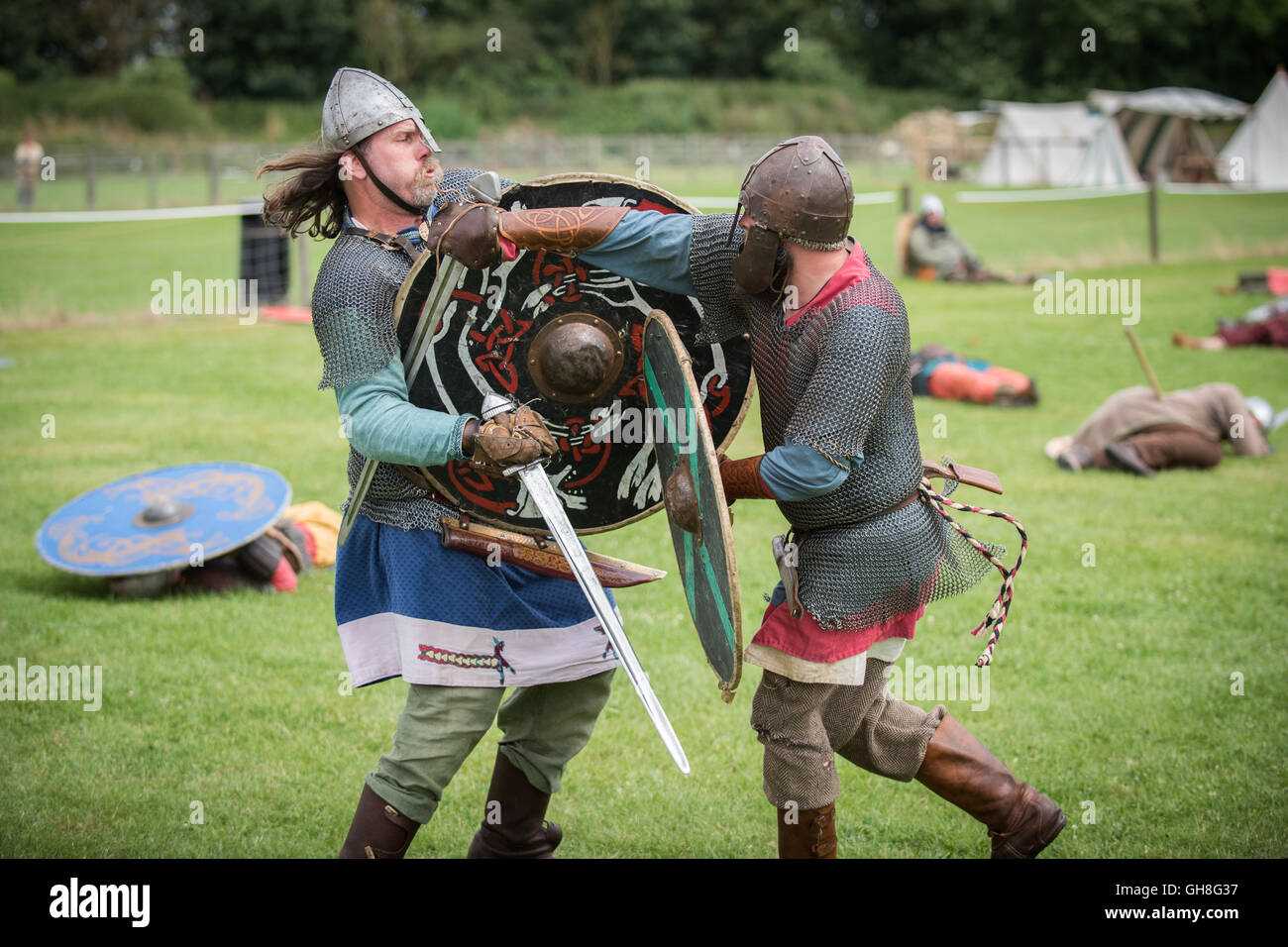 Viking battle reenactment. One on one combat. Kill stroke, sword under ...