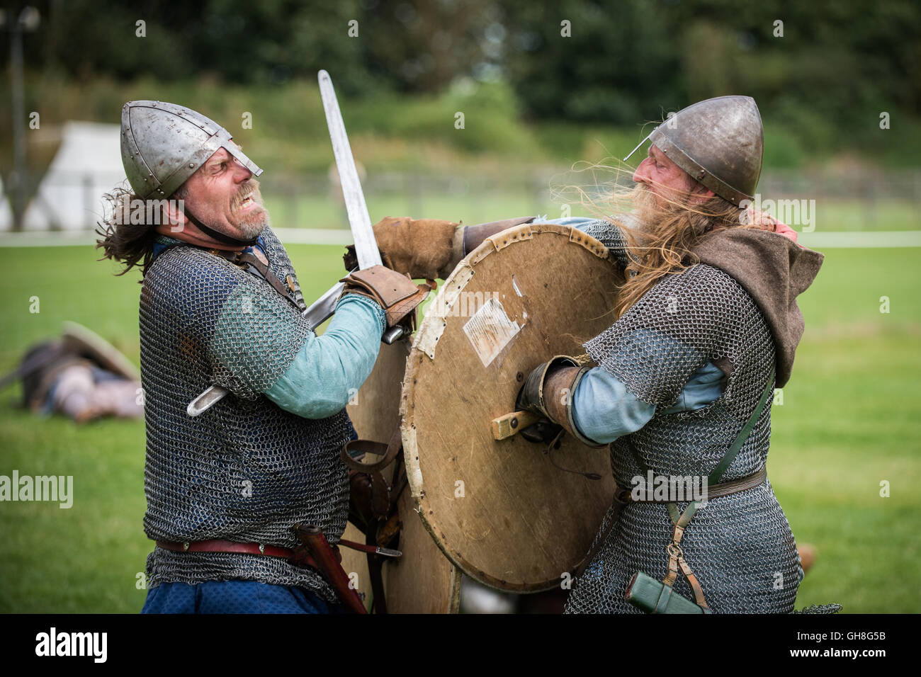 Viking reenactment battle. kills stroke. Sword to under arm Stock Photo ...