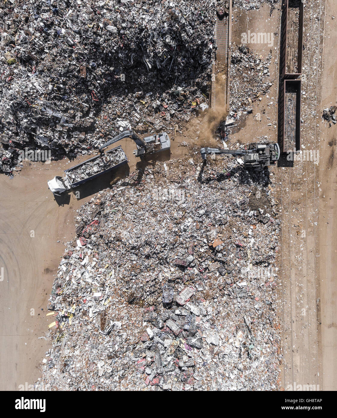 Iron raw materials recycling pile, work machines. Metal waste junkyard ...