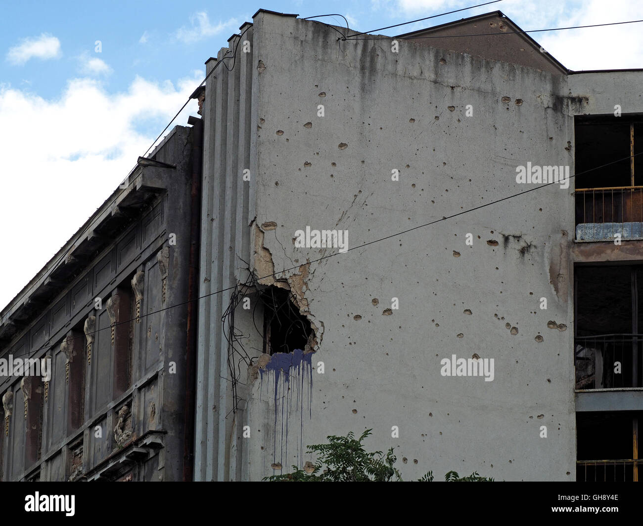 side wall of tall building in Mostar pockmarked with missile shell and ...