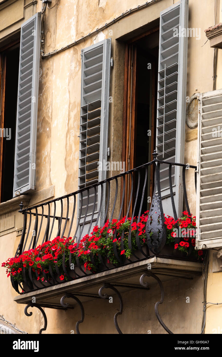Ancient Italian architecture with decorative balcony filled with ...