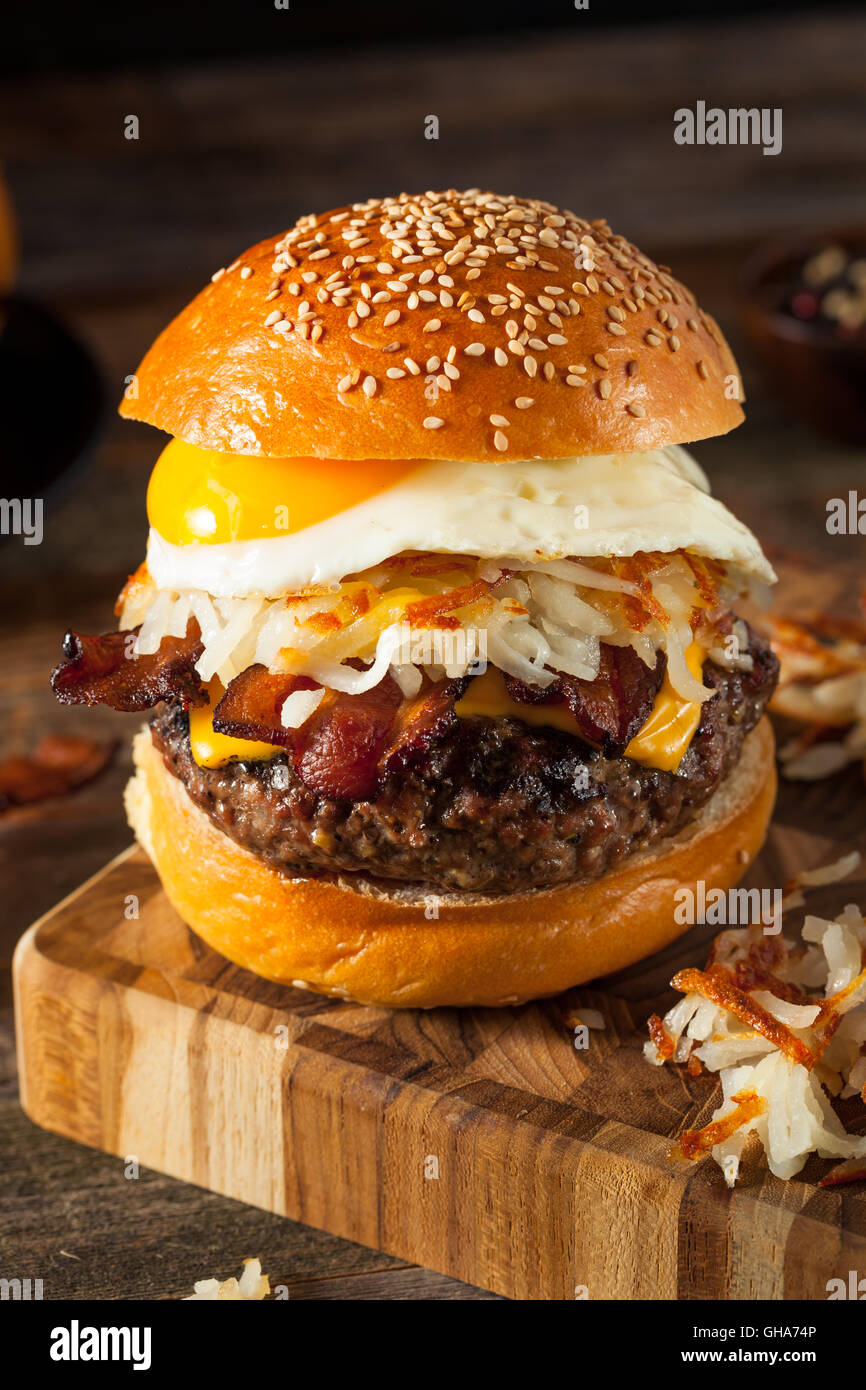 Homemade Breakfast Cheeseburger with Bacon Eggs and Hashbrowns Stock ...