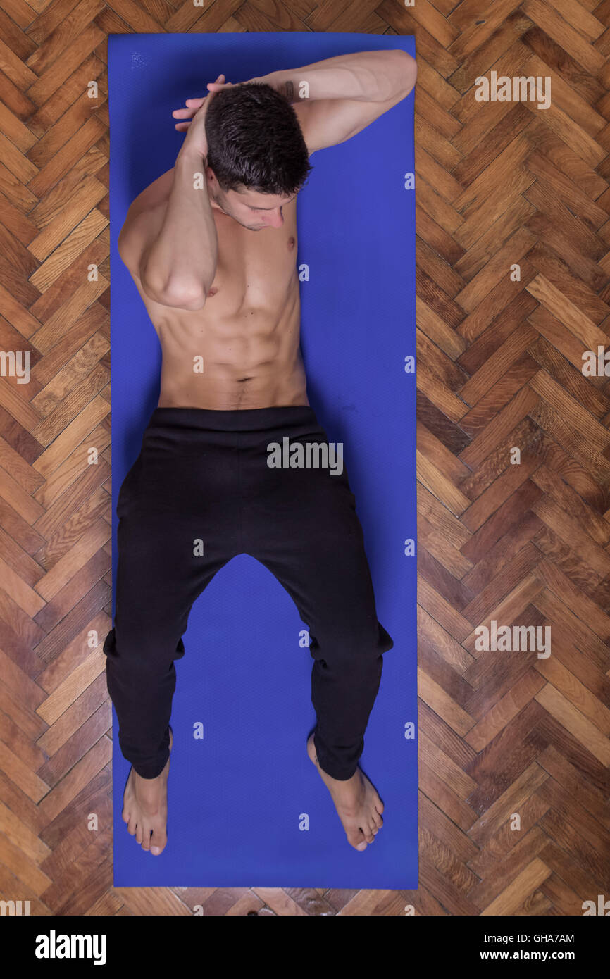 Young man practicing abs crunches hi-res stock photography and images ...