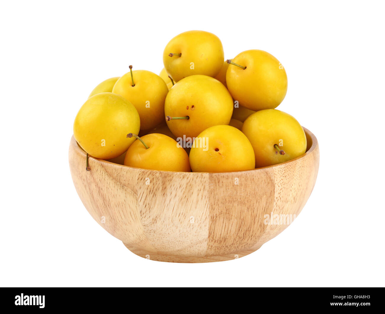 Mellow ripe fresh yellow cherry plums in wooden bowl isolated on white ...