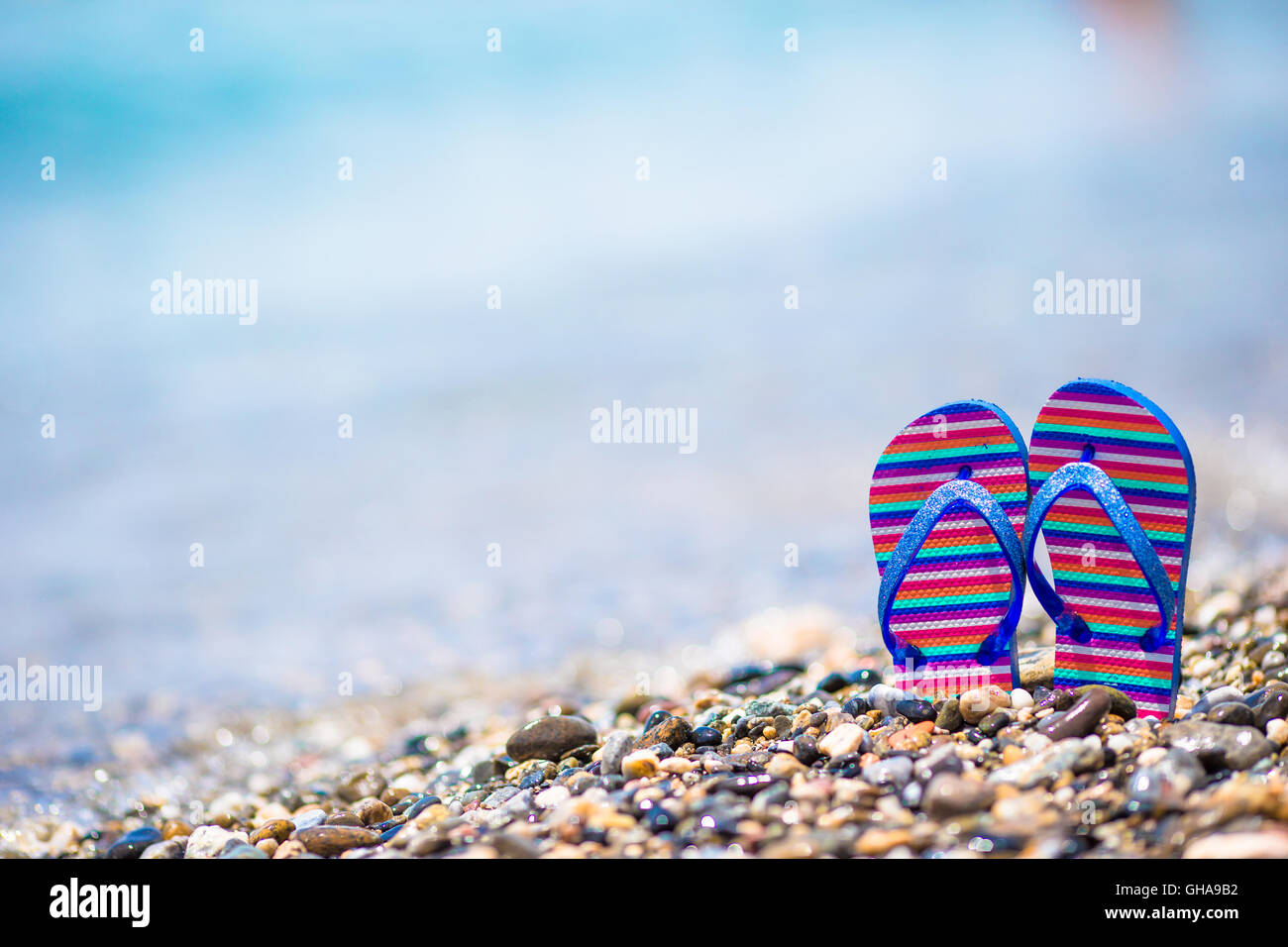 Kids flip flop on beach in front of the sea Stock Photo - Alamy