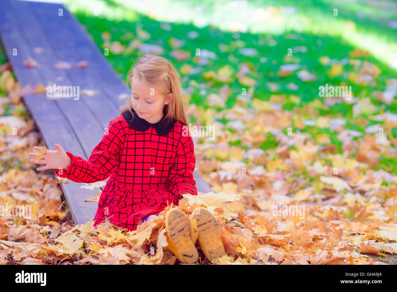 Adorable little girl outdoors at beautiful autumn day Stock Photo - Alamy