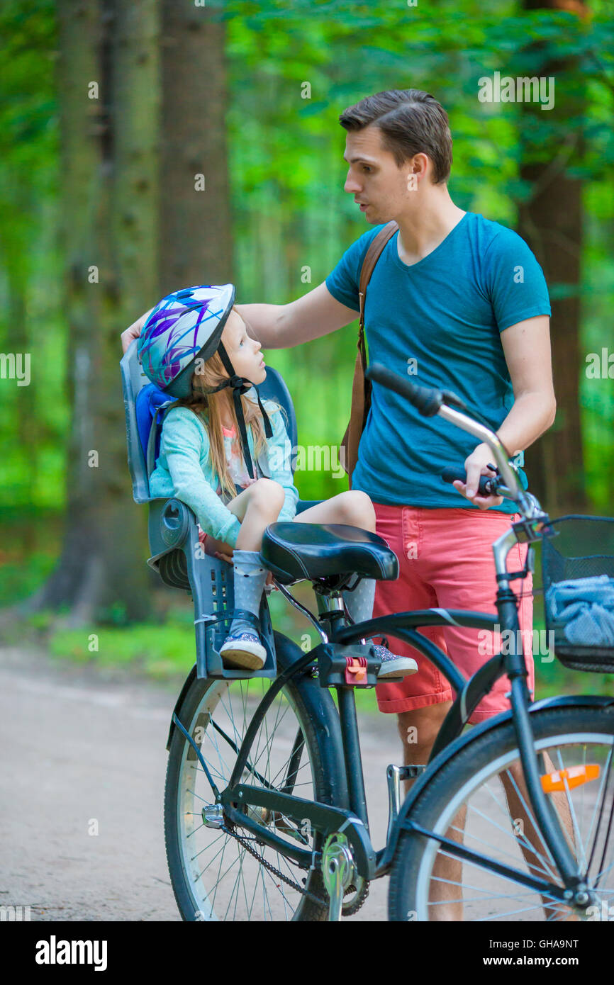 Happy family biking outdoors at the park Stock Photo - Alamy
