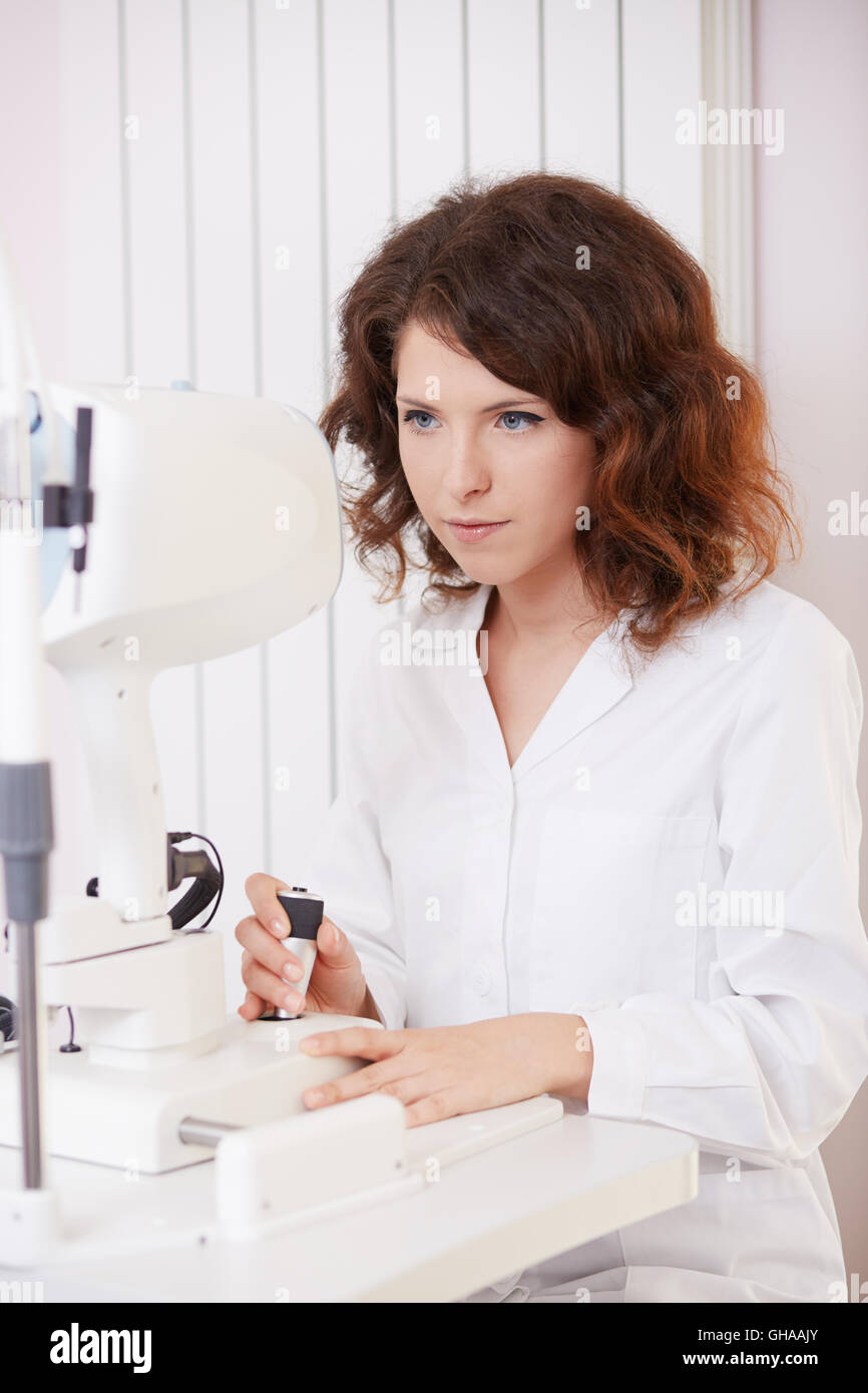 pretty young optometrist at work, examinating your eyes Stock Photo - Alamy
