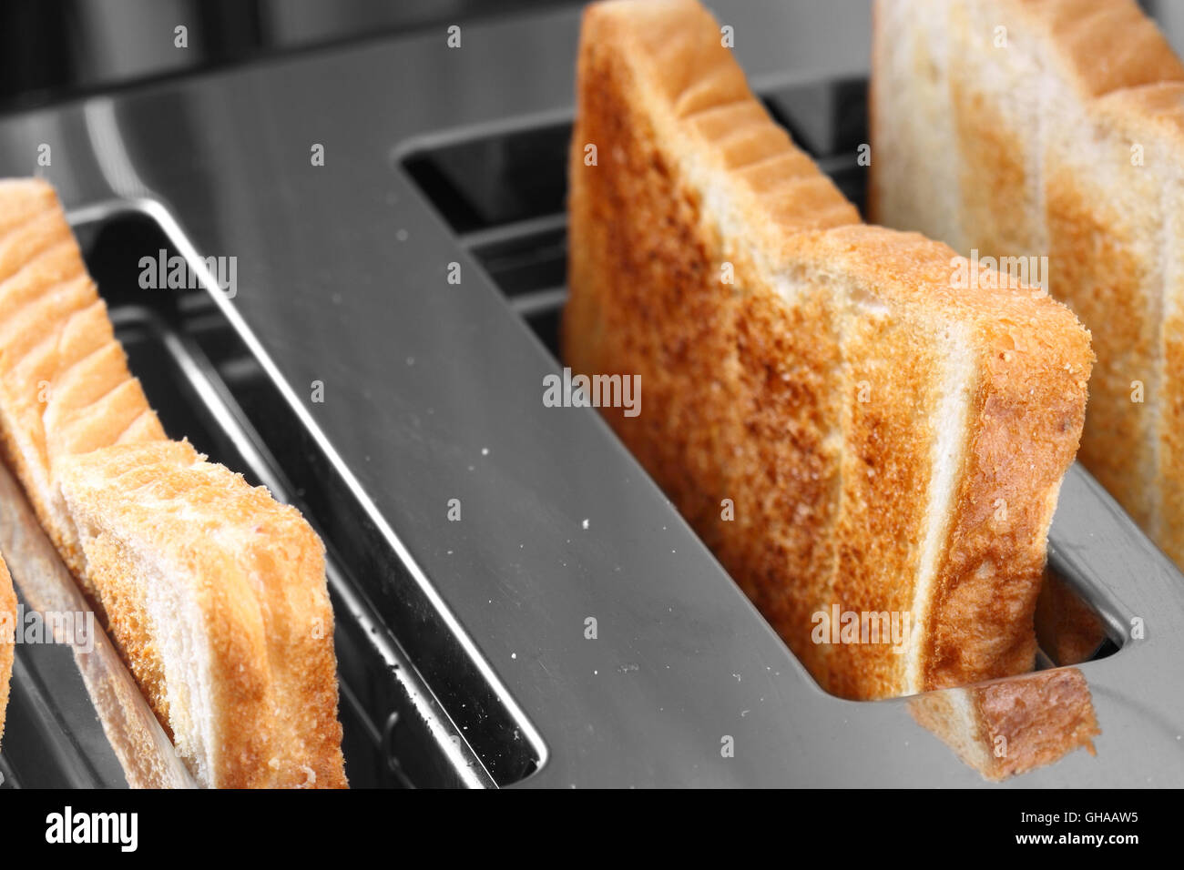 Slices of toast in a toaster Stock Photo - Alamy