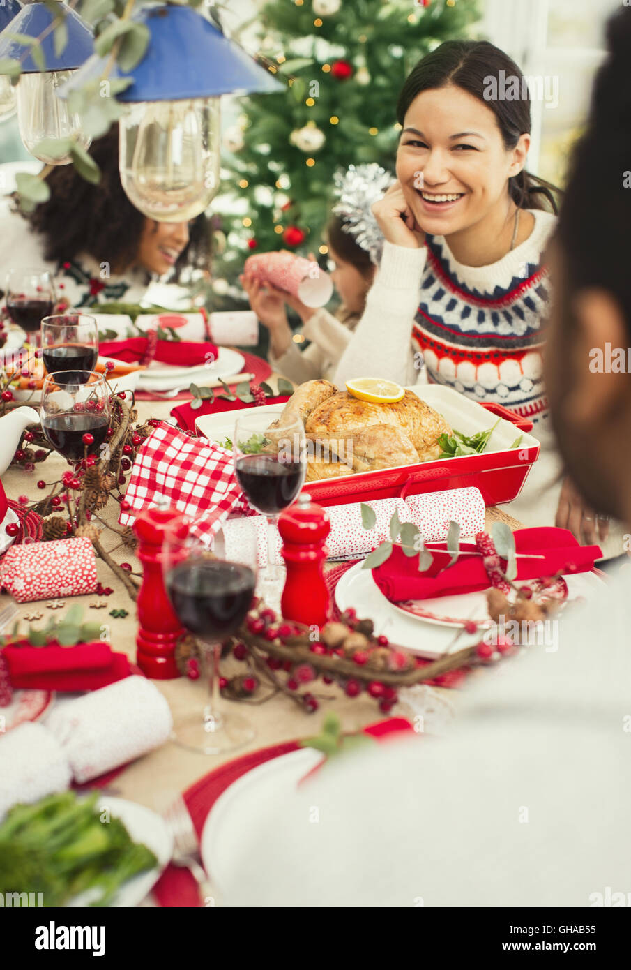 Smiling woman enjoying Christmas dinner Stock Photo - Alamy