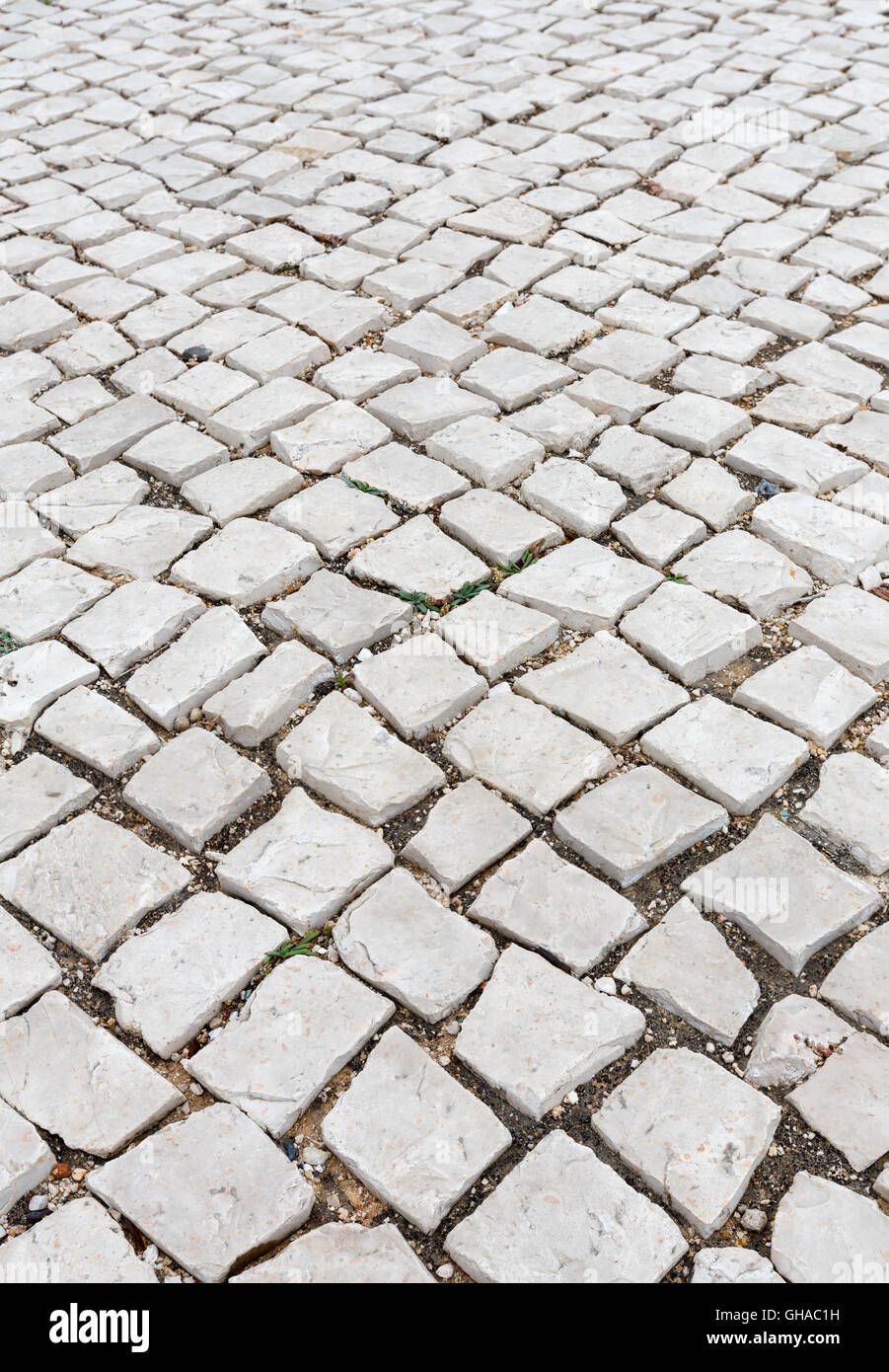 Cobbled road closeup in town as background Stock Photo - Alamy