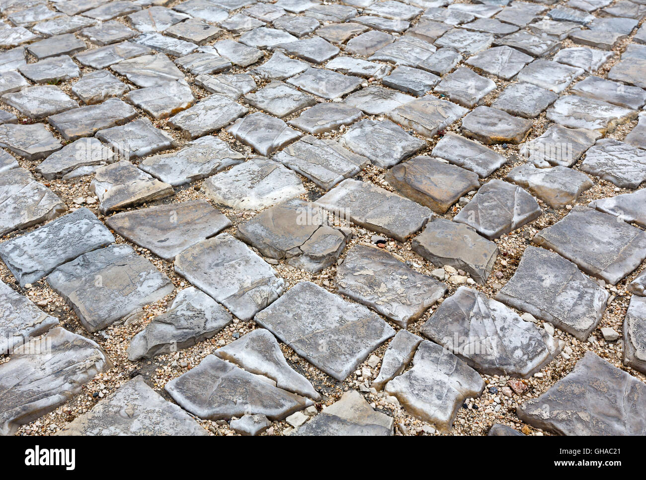 Cobbled road closeup in town as background Stock Photo - Alamy
