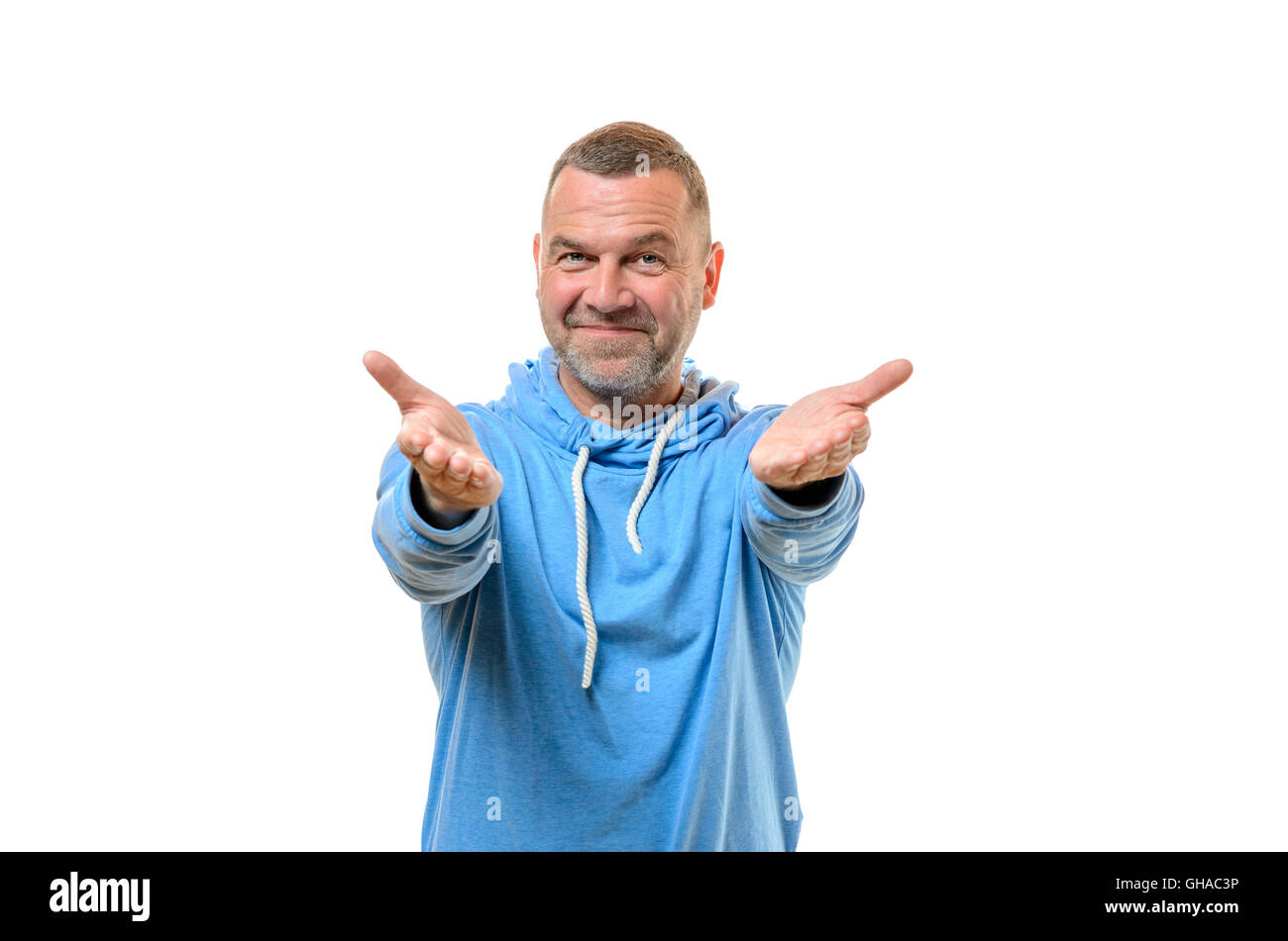 Welcoming friendly middle-aged man holding out his outstretched hands ...