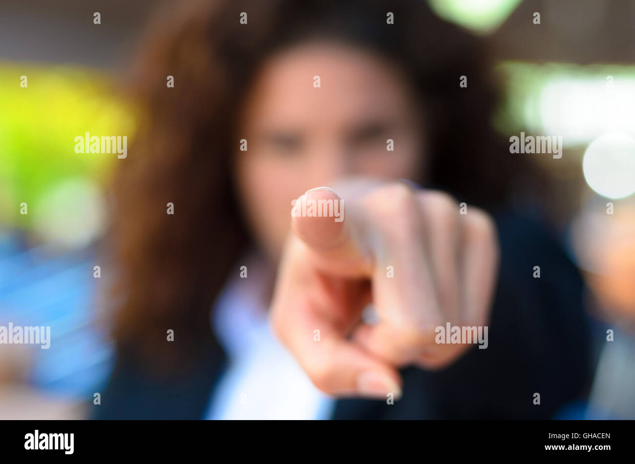 Woman pointing an accusatory finger at the camera with selective focus ...