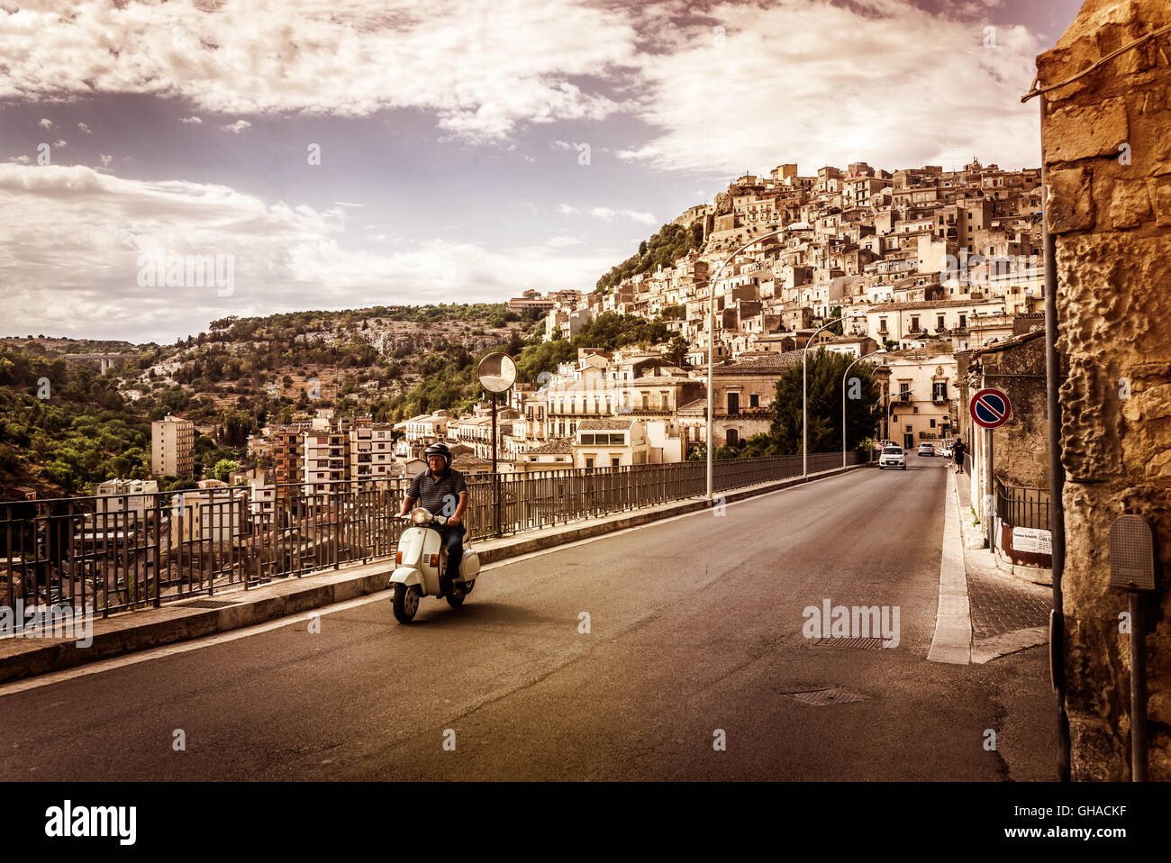 Riding a an iconic italian scooter in Modica, south of Sicily Stock ...