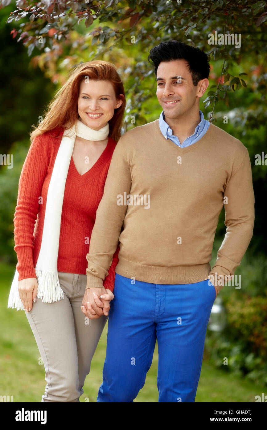Happy couple walking together Stock Photo - Alamy