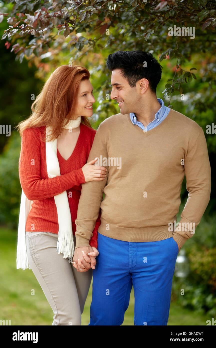 Happy couple walking together Stock Photo - Alamy