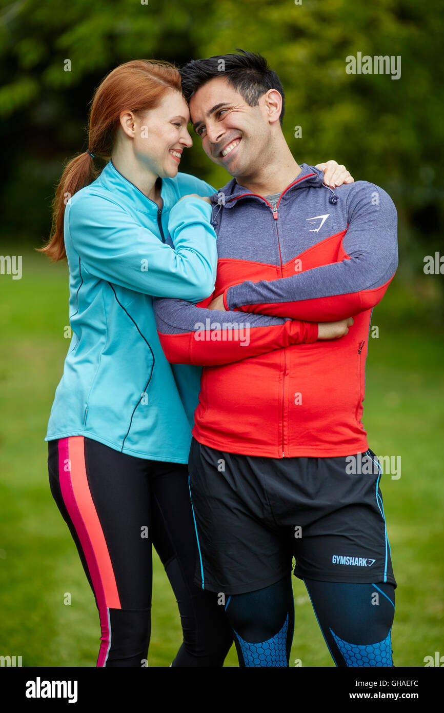 Couple exercising together outdoors Stock Photo - Alamy