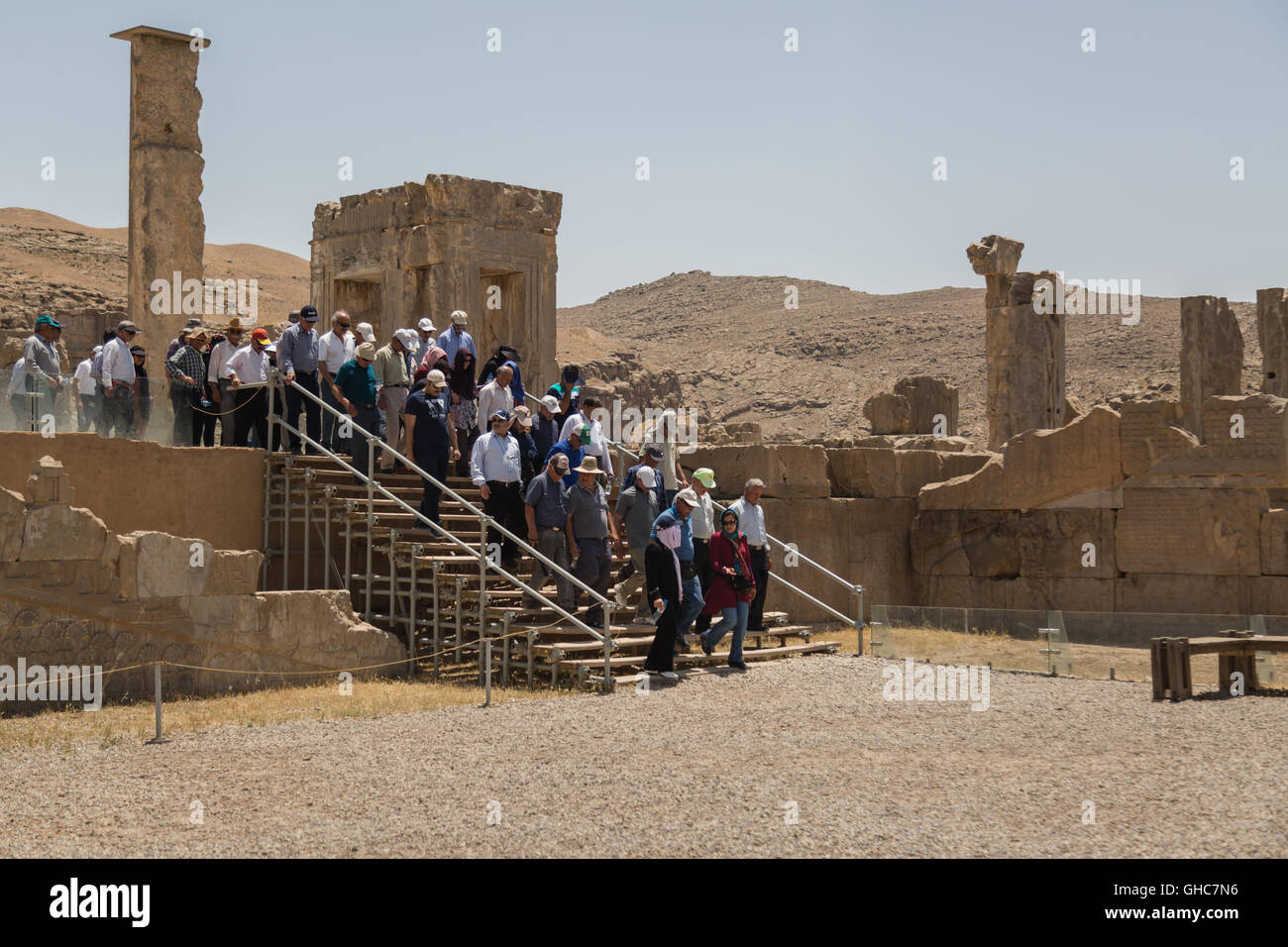 A crowd of tourists descending the stairs of Persepolis, in MarvDasht ...